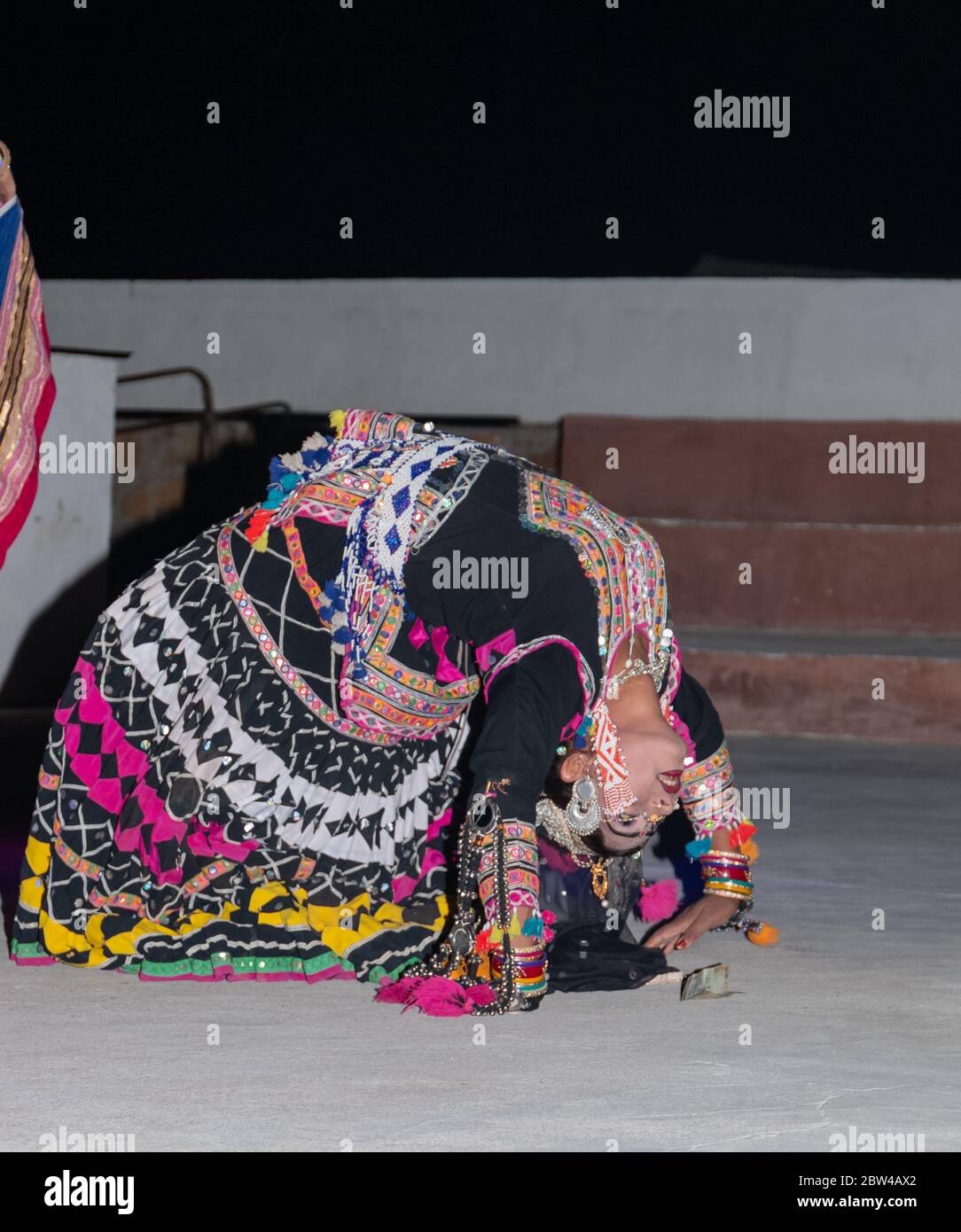 Indian female artist performing Kalbelia folk dance with mud pots in ...