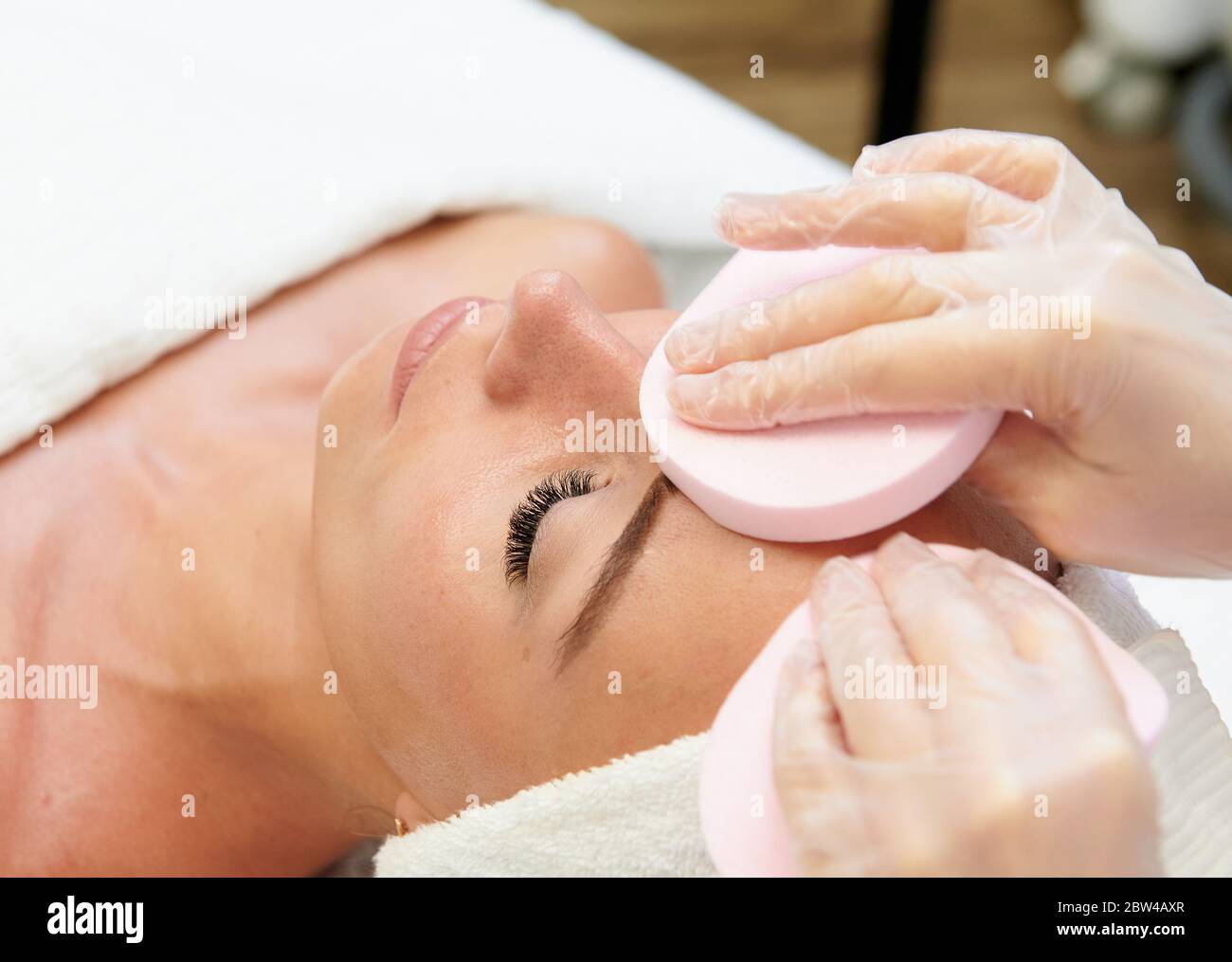 Cleaning forehead with facial sponges spa treatment professional ...