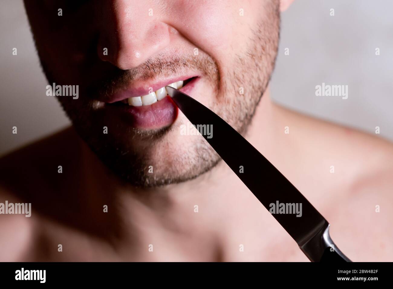 Knife between teeth hi-res stock photography and images - Alamy