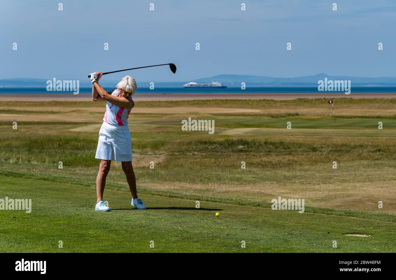 Woman playing golf at Golf Club reopening, Kilspindie golf course ...