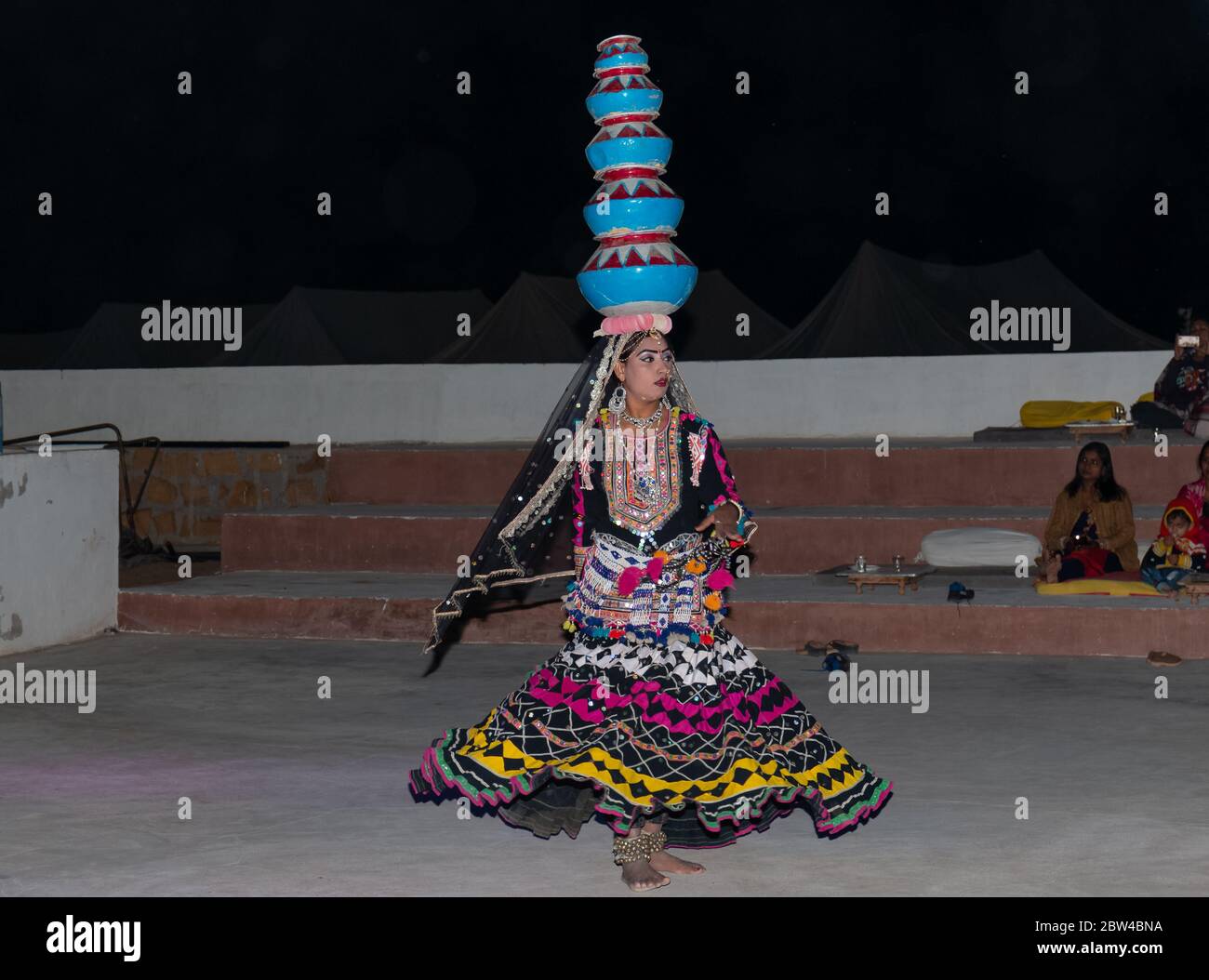 Indian female artist performing Kalbelia folk dance with mud pots in ...