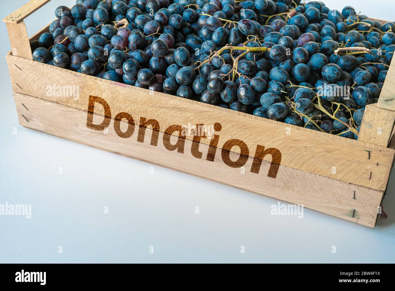 crate with fresh raw fruits to send as the donation to poor children ...