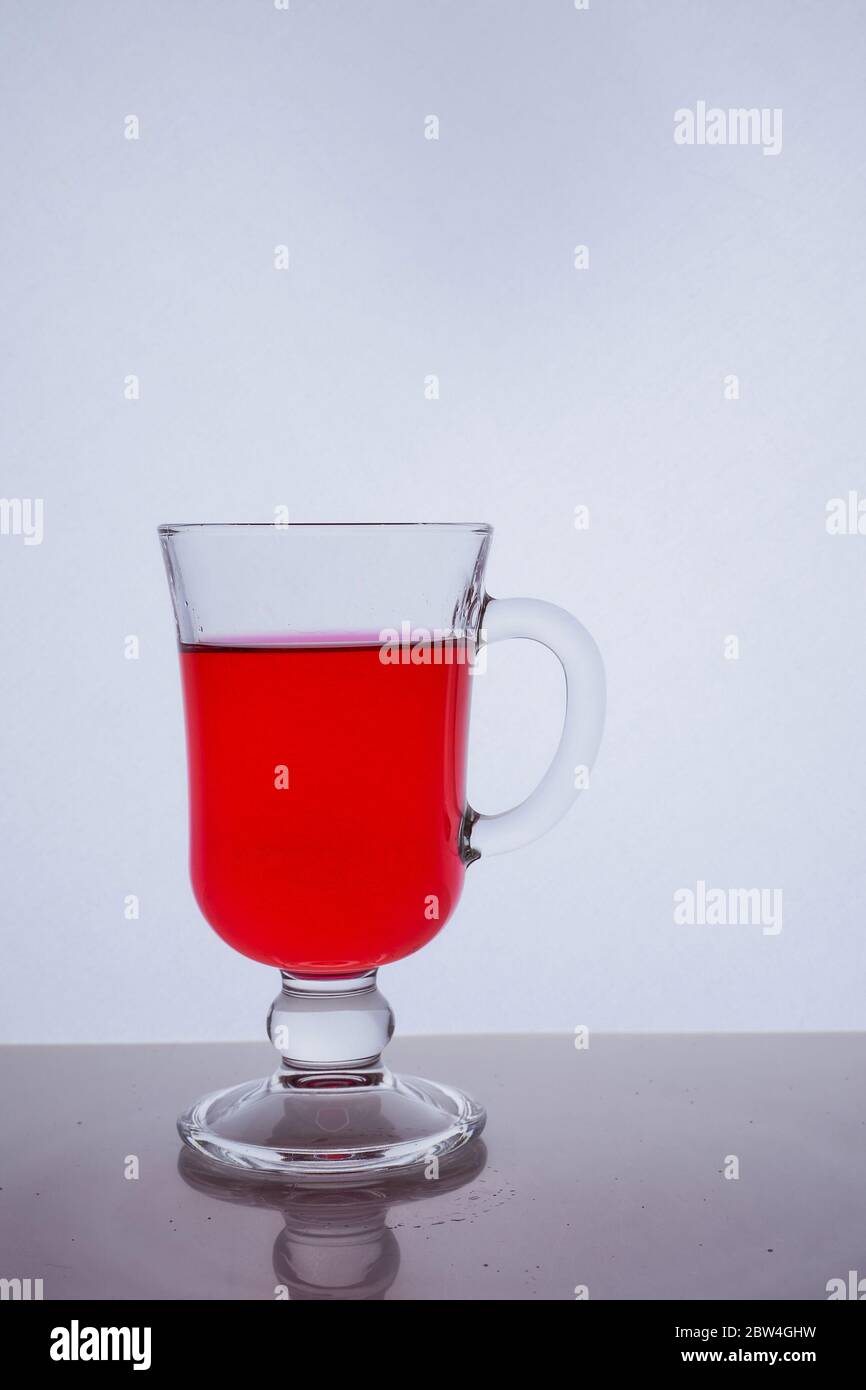 red liquid into a glass on a white background light effect Stock Photo ...