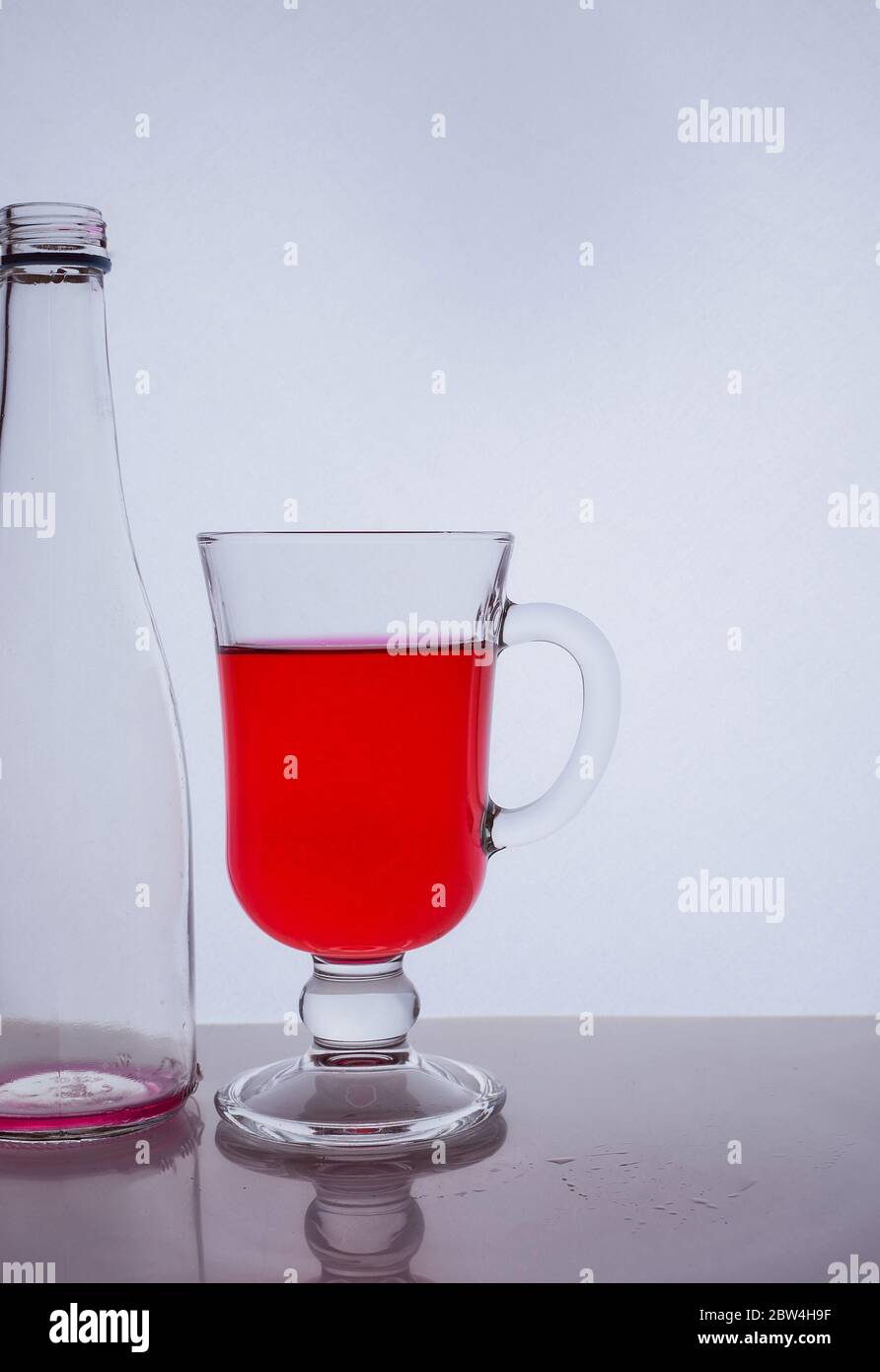 red liquid into a glass on a white background light effect Stock Photo ...