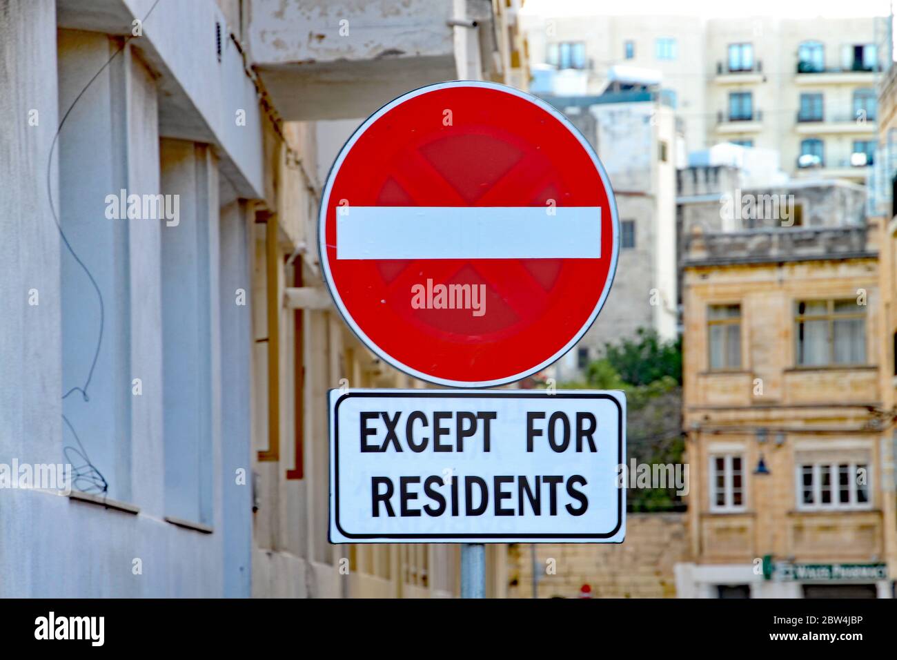 Red and white circular no entry sign except for residents in front of a ...