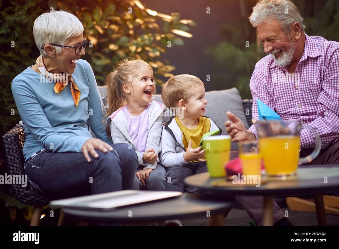 Cheerful kids spending good and funny time with their happy ...
