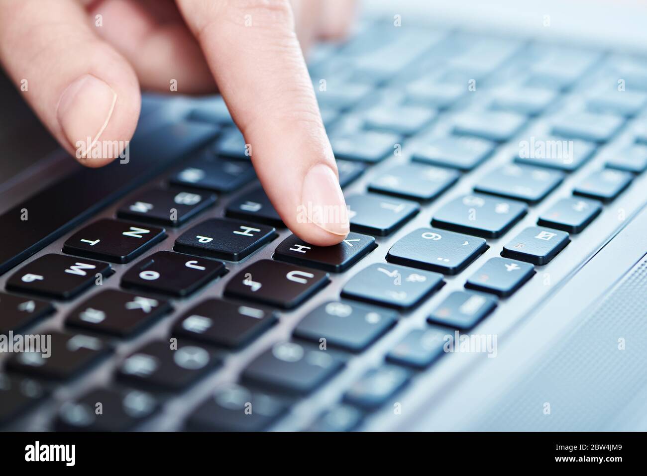 Female hand on laptop keyboard closeup Stock Photo - Alamy