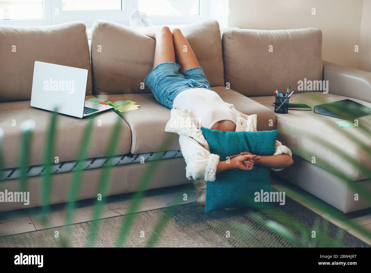 Bored girl lying on sofa at home hi-res stock photography and images ...