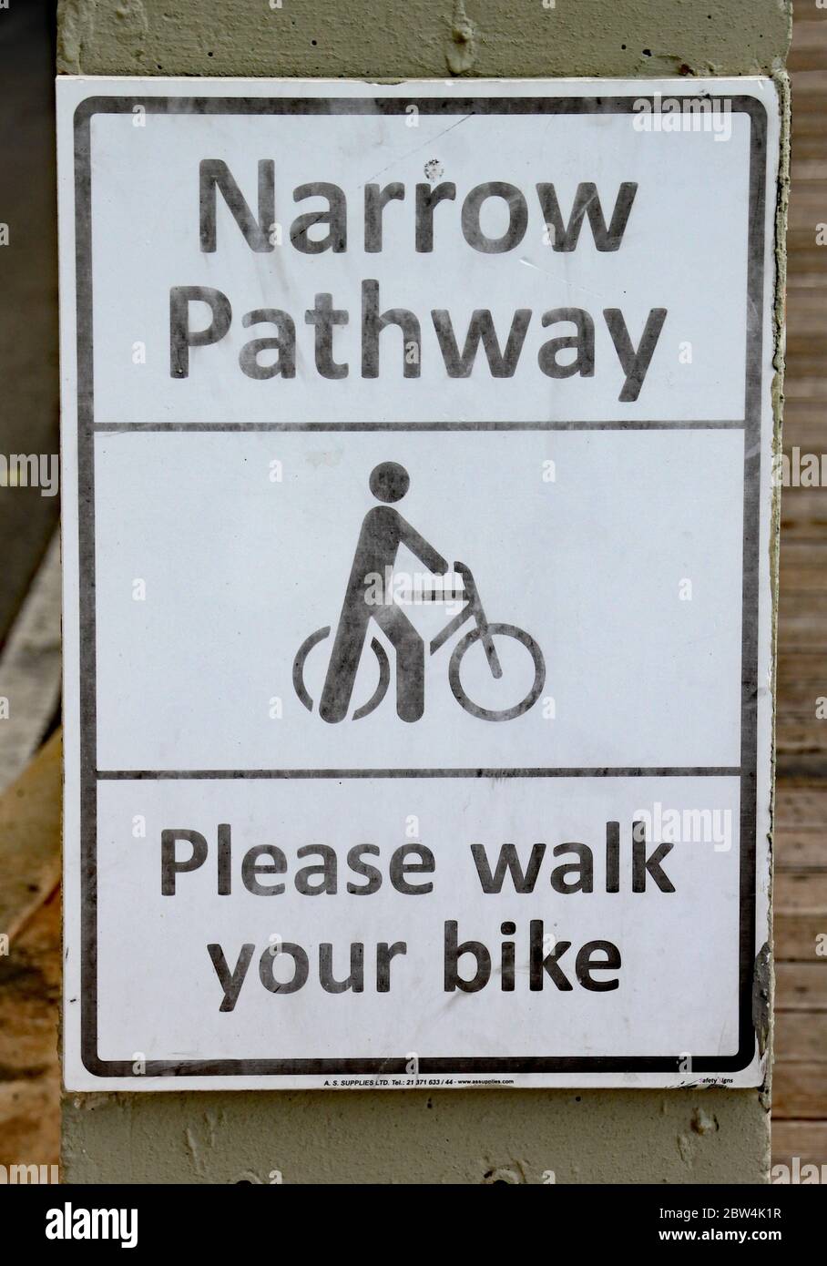 sign warning of narrow pathway and to please walk your bike Stock Photo ...