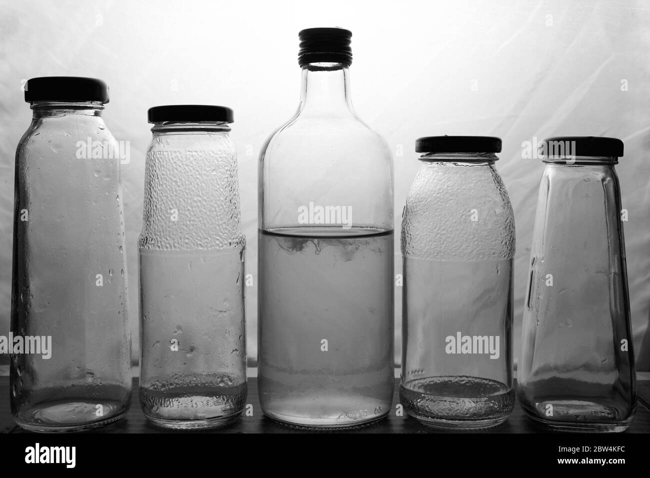 composition of glass bottles on a light background Stock Photo - Alamy