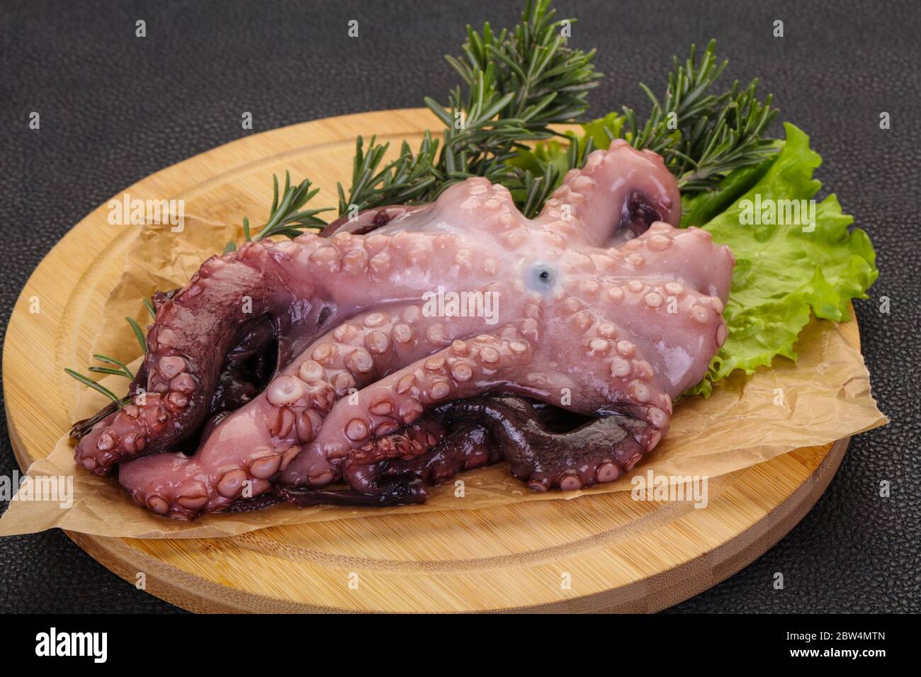 Raw octopus ready for cooking with rosemary Stock Photo - Alamy