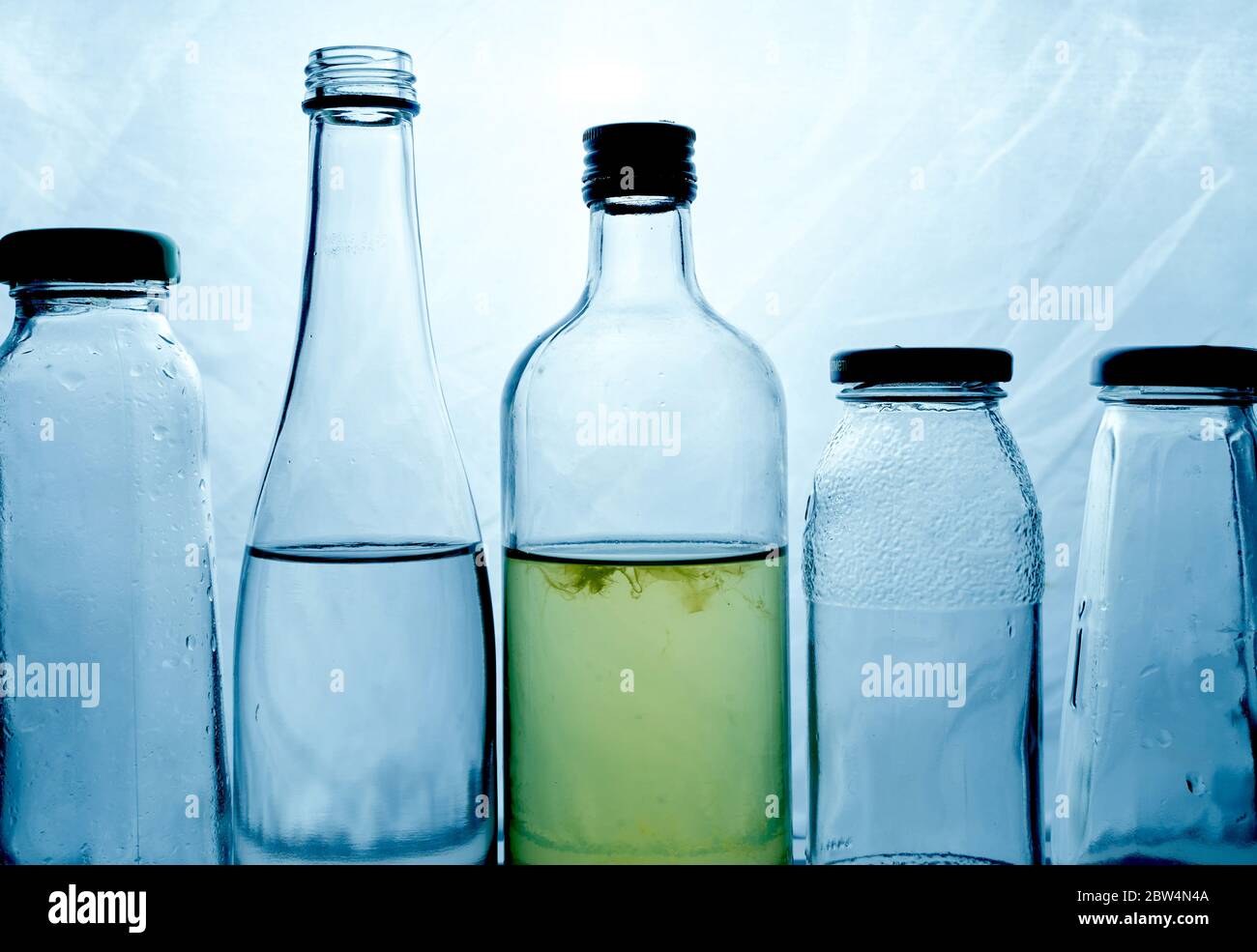 composition of glass bottles on a light background Stock Photo - Alamy