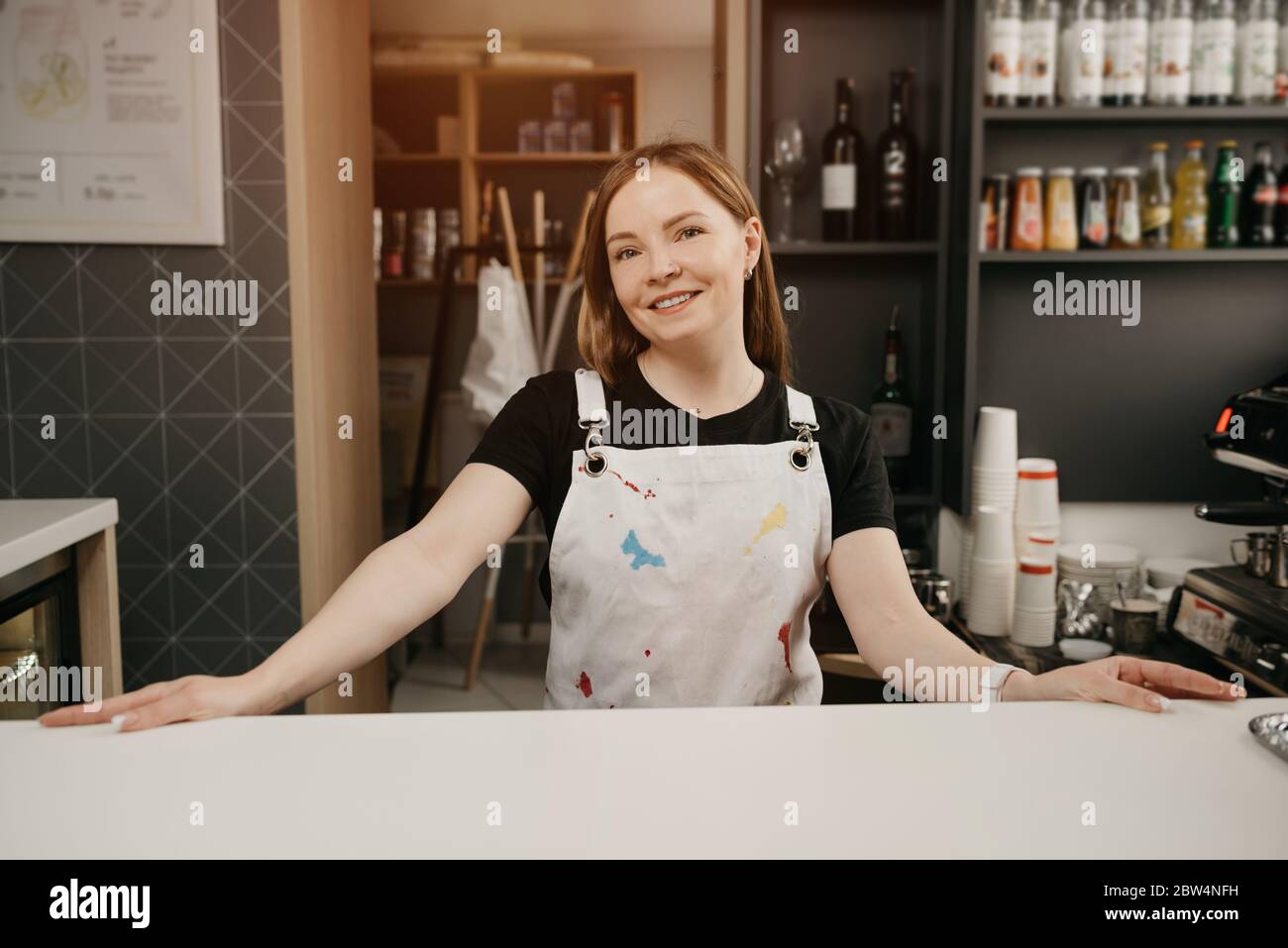 Girl standing behind table hi-res stock photography and images - Alamy