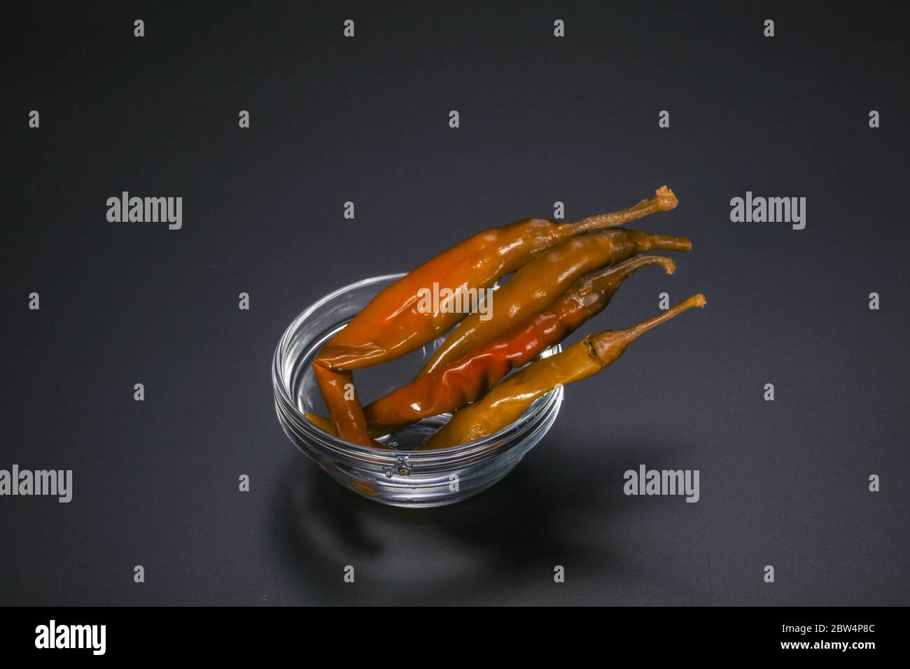 Marinated chilli pepper heap in the bowl Stock Photo - Alamy