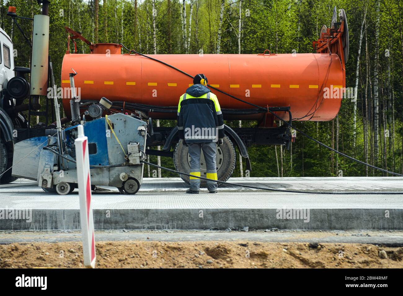 People on road equipment build a concrete road pavement Stock Photo - Alamy
