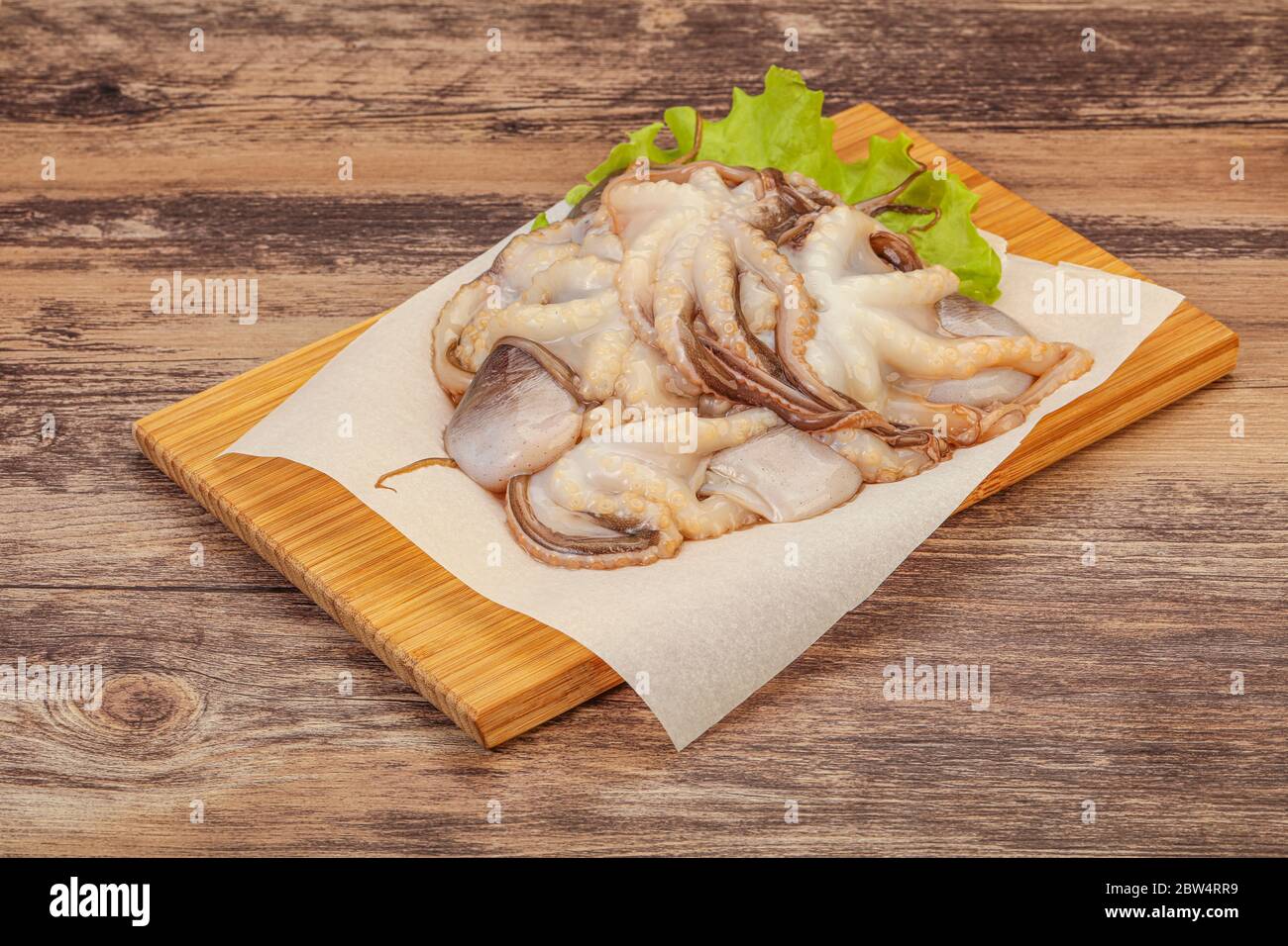 Raw seafood - octopus for cooking over the board Stock Photo - Alamy