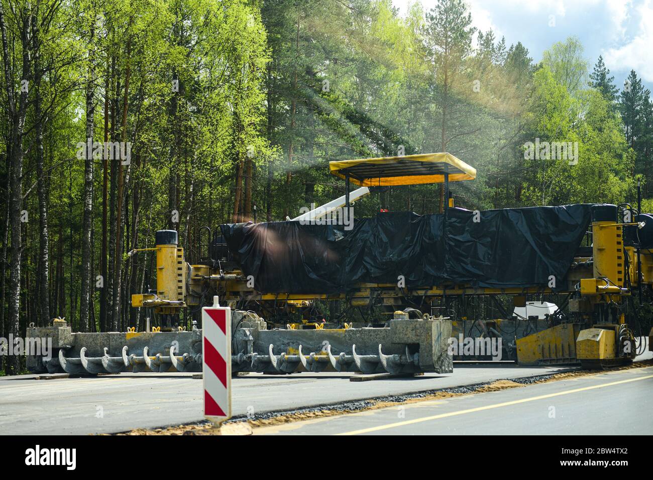 People on road equipment build a concrete road pavement Stock Photo - Alamy