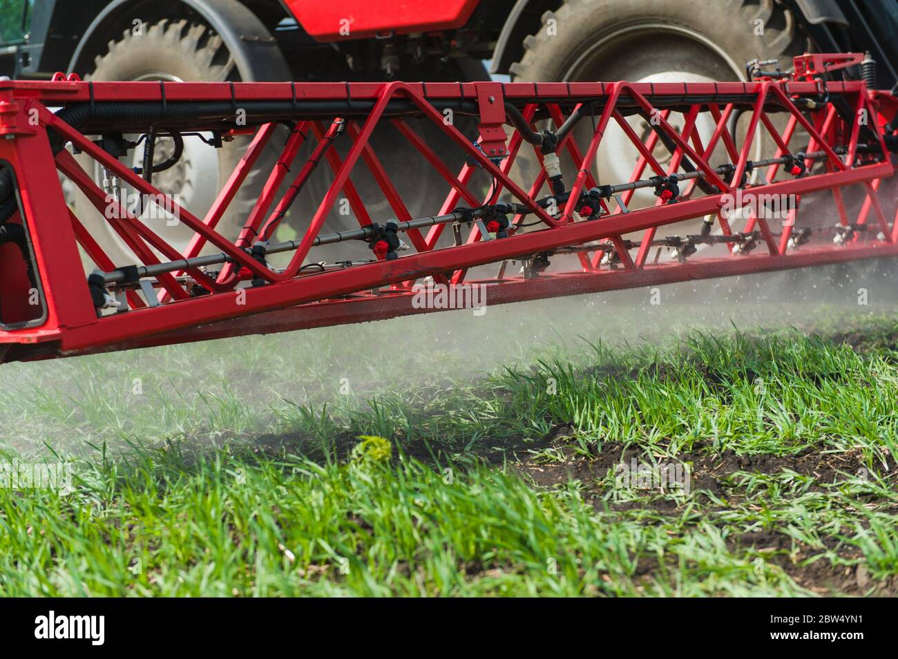 Close up wheels, boom of spray machine Stock Photo - Alamy