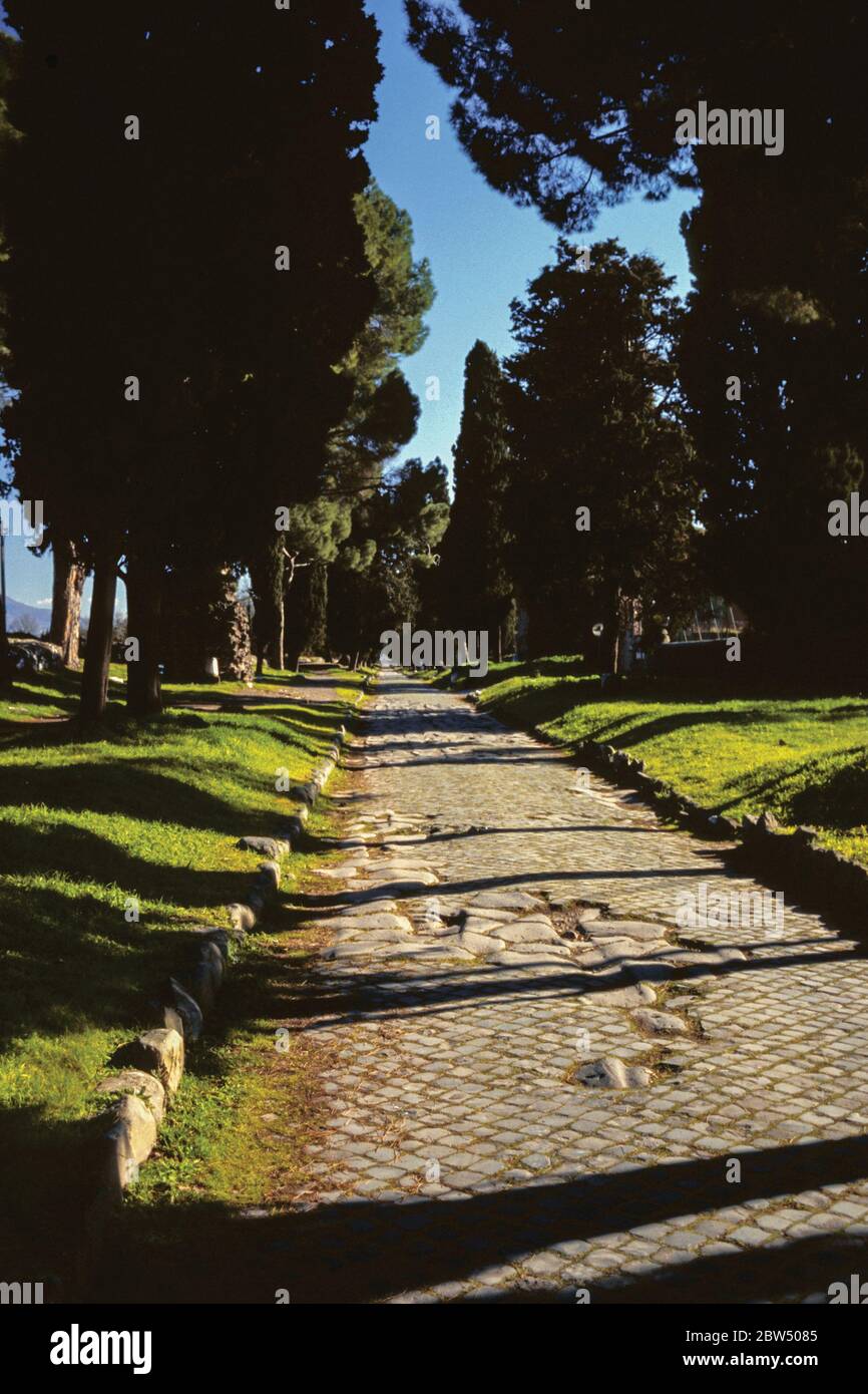 View of the Appian Way, an ancient Roman road covered by original cobblestone that connects the ...