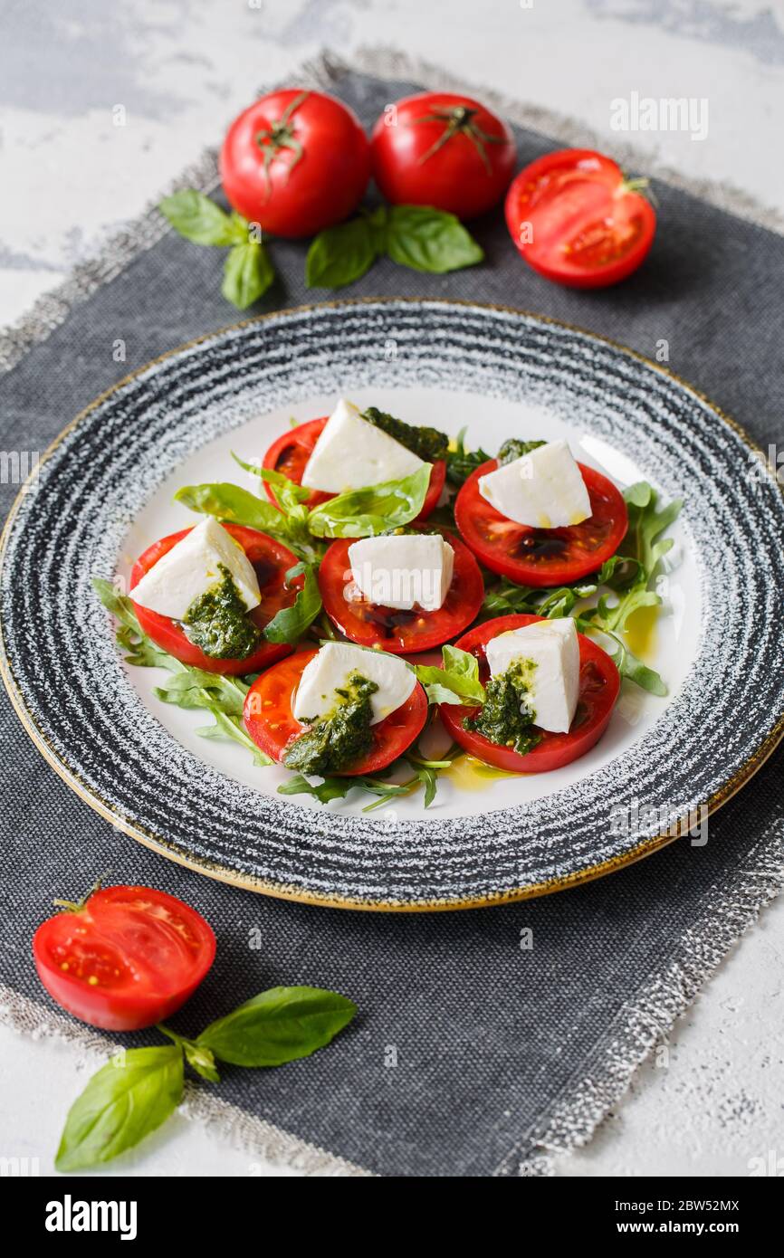 Classic caprese salad. Tomatoes, mozzarella and pesto Stock Photo - Alamy