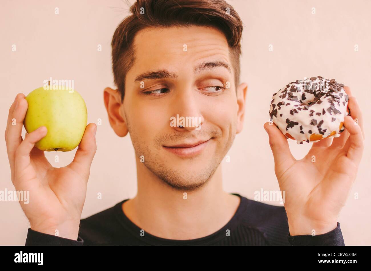 Funny sports man struggling what to choose for his dieting: unhealthy ...