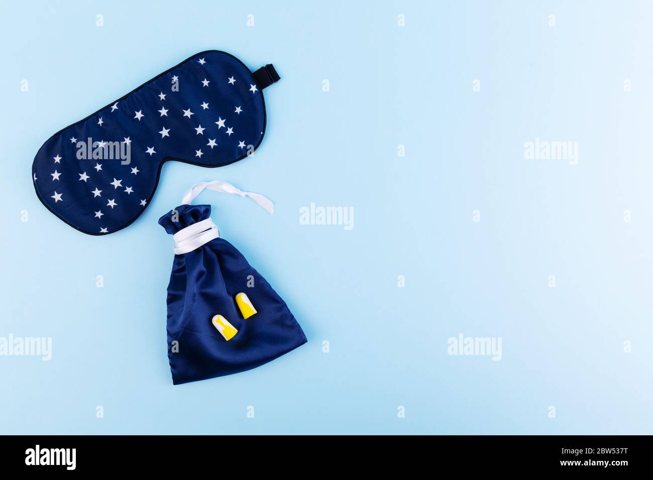 Good sleep concept: blue sleep mask and earplugs on blue background ...