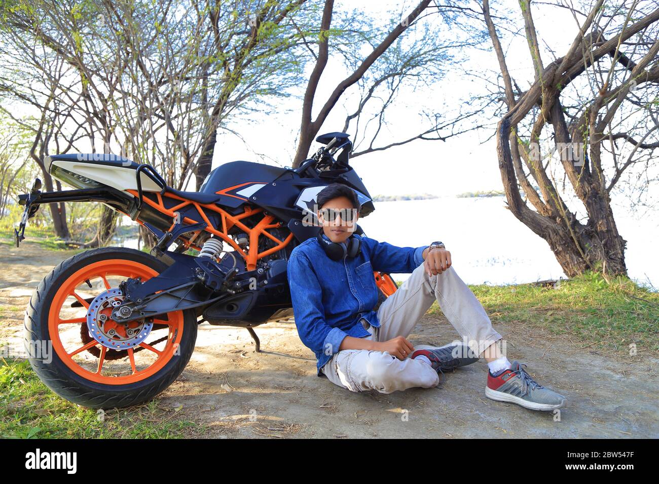 Stylish male model with motorcycle or sports bike Stock Photo - Alamy