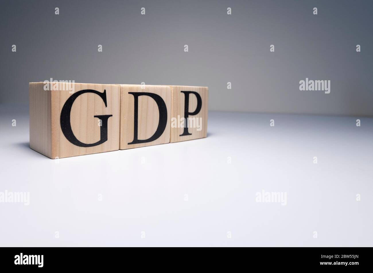 Gdp word in spot light on white background. Close up Stock Photo - Alamy
