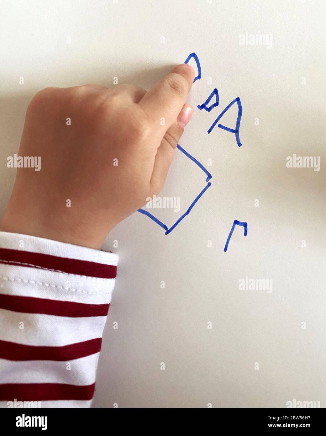 Small boy's hand hand pointing to drawns. Top view Stock Photo - Alamy
