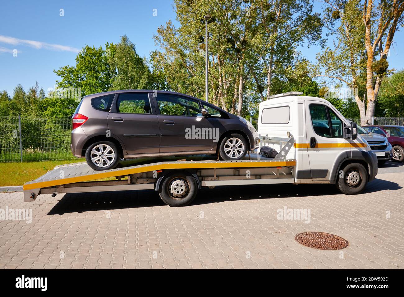 A car on tow truck for emergency car move Stock Photo - Alamy