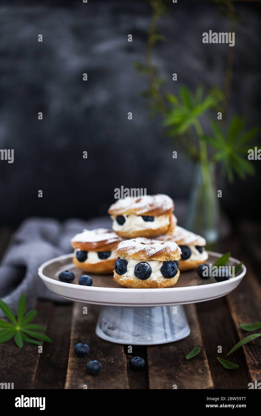 Cream puff rings (choux pastry) decorated with fresh blueberries Stock ...