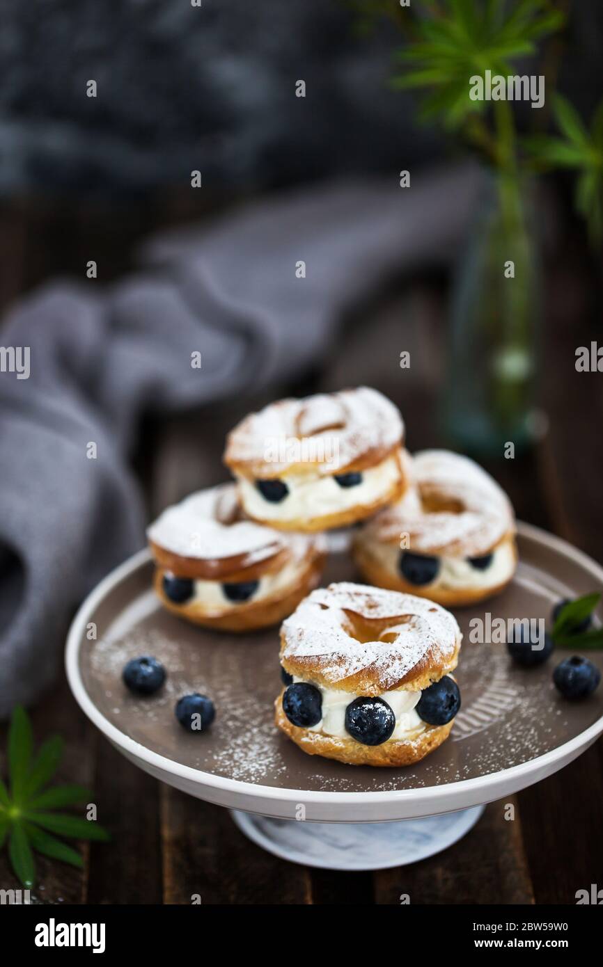 Cream puff rings (choux pastry) decorated with fresh blueberries Stock ...
