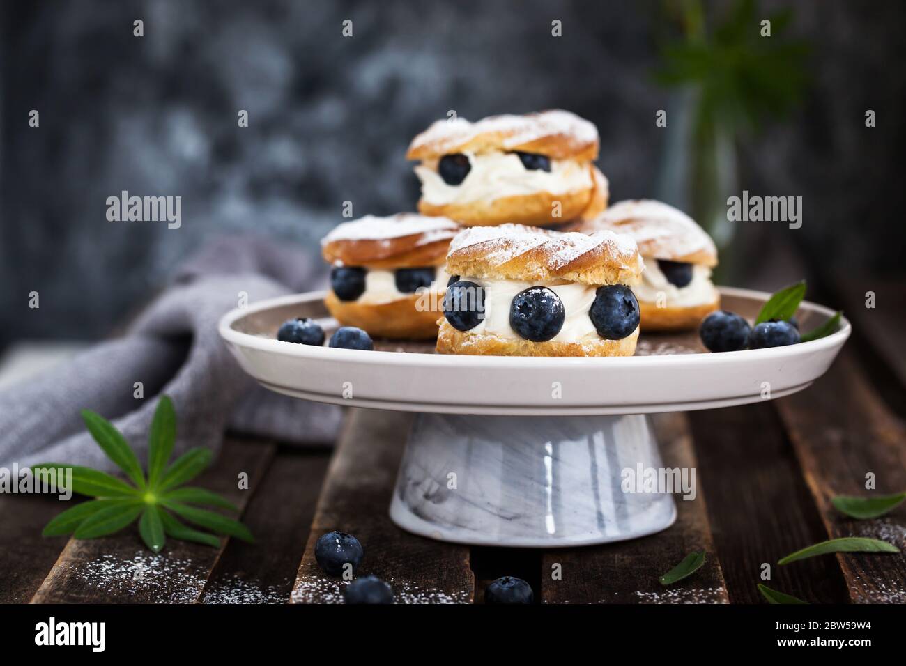 Cream puff rings (choux pastry) decorated with fresh blueberries Stock ...
