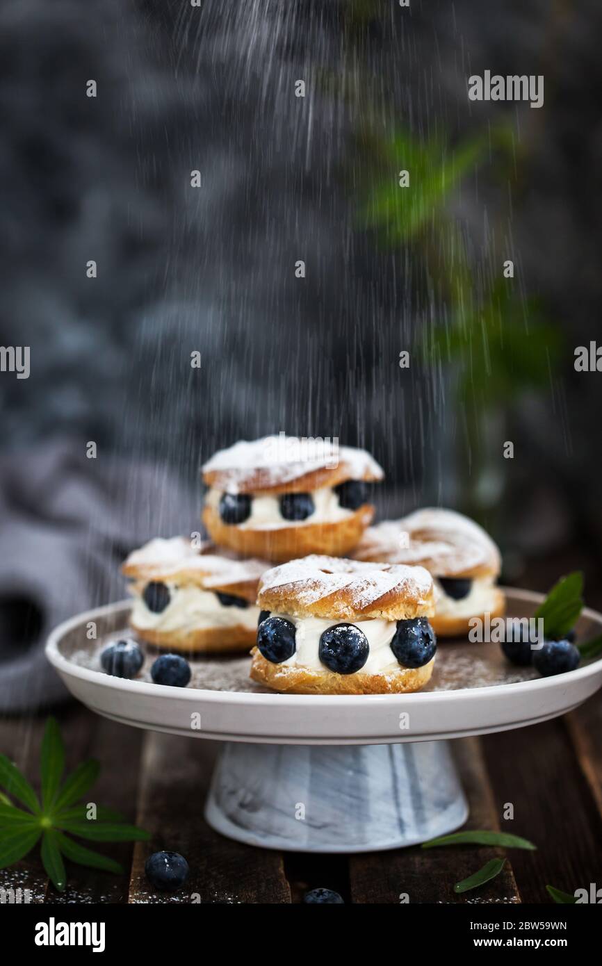Cream puff rings (choux pastry) decorated with fresh blueberries Stock ...