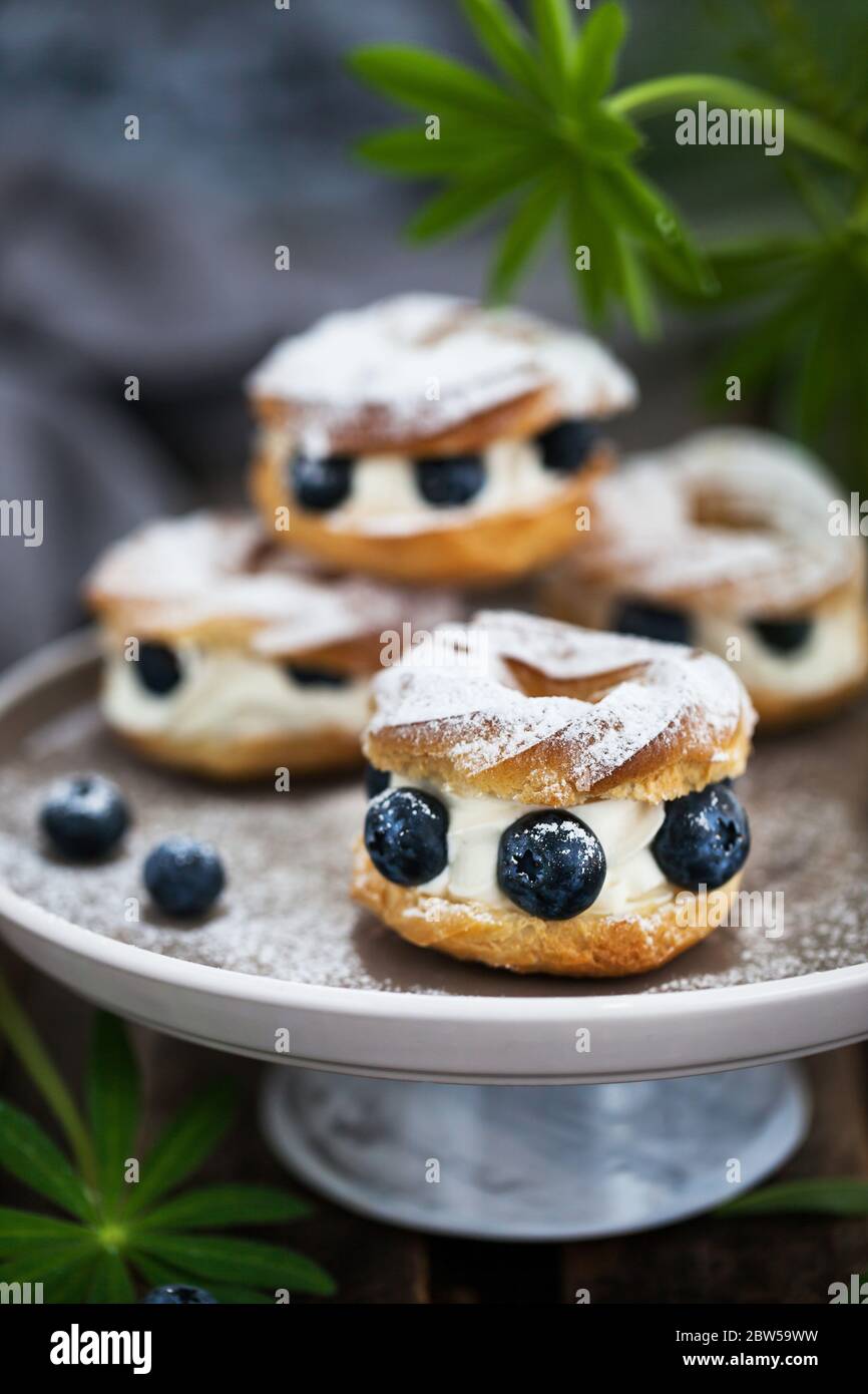 Cream puff rings (choux pastry) decorated with fresh blueberries Stock ...