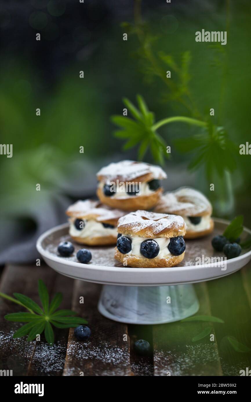 Cream puff rings (choux pastry) decorated with fresh blueberries Stock ...