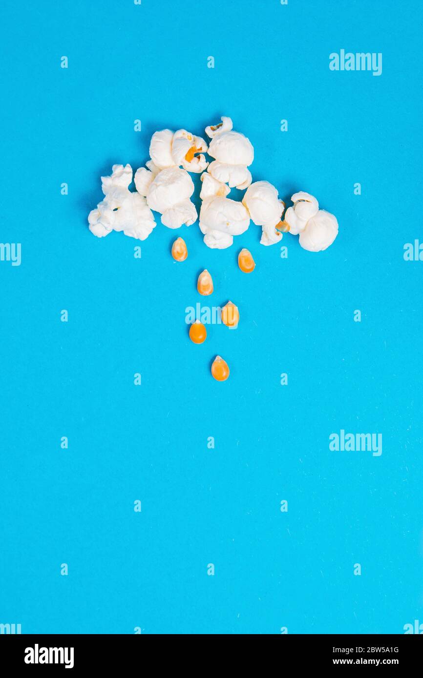 Rainy cloud made out of popcorn on a blue background Stock Photo - Alamy