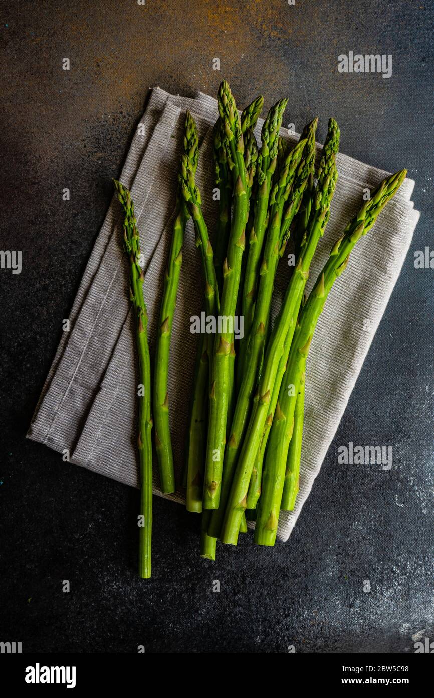 Organic food concept with asparagus on stone table with copy space ...