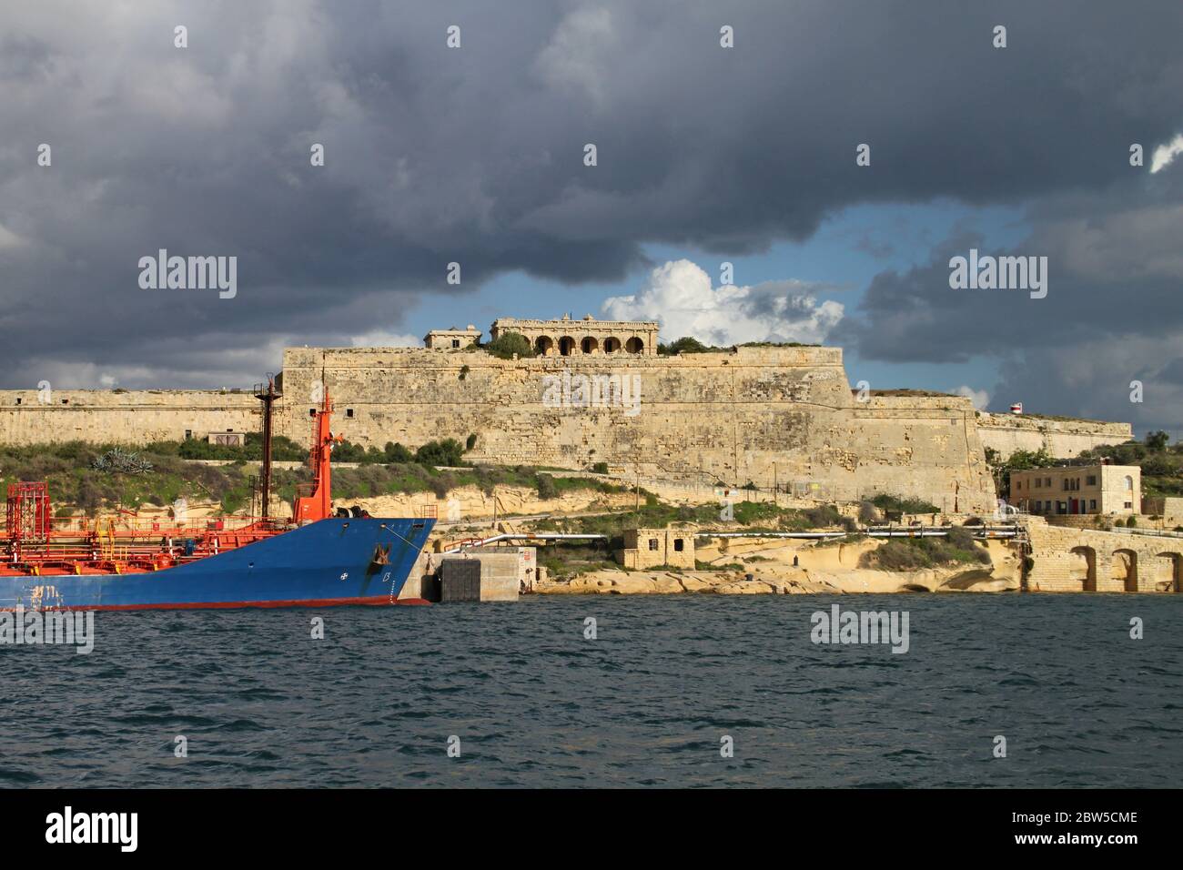 A cargo ship is docked in the harbour in Valletta, Malta Stock Photo ...