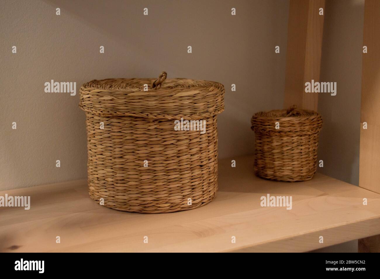 Wicker baskets on a wooden shelf. Accessories for the interior Stock ...