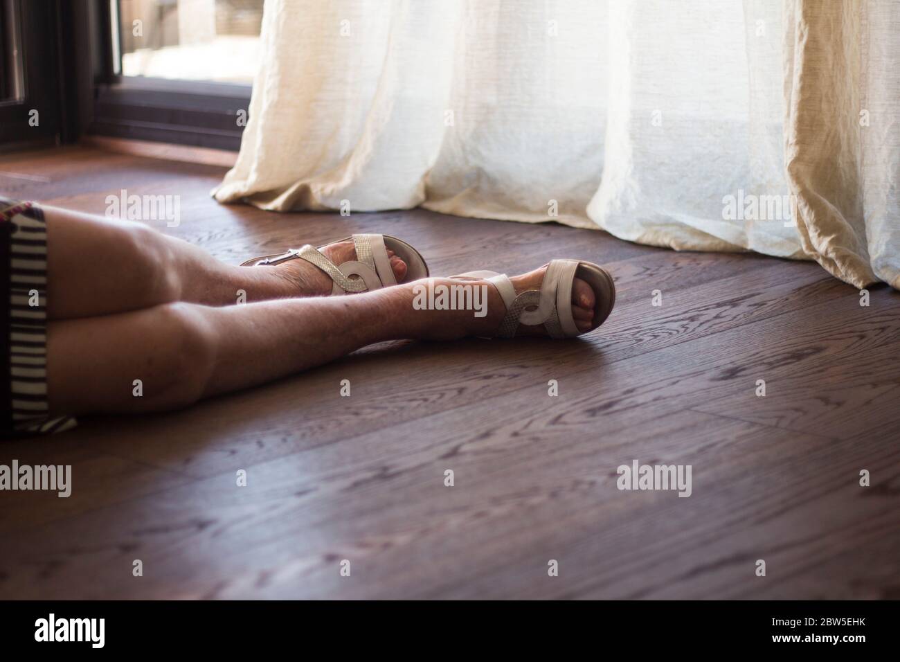 Elderly woman lying on floor after fall Stock Photo - Alamy