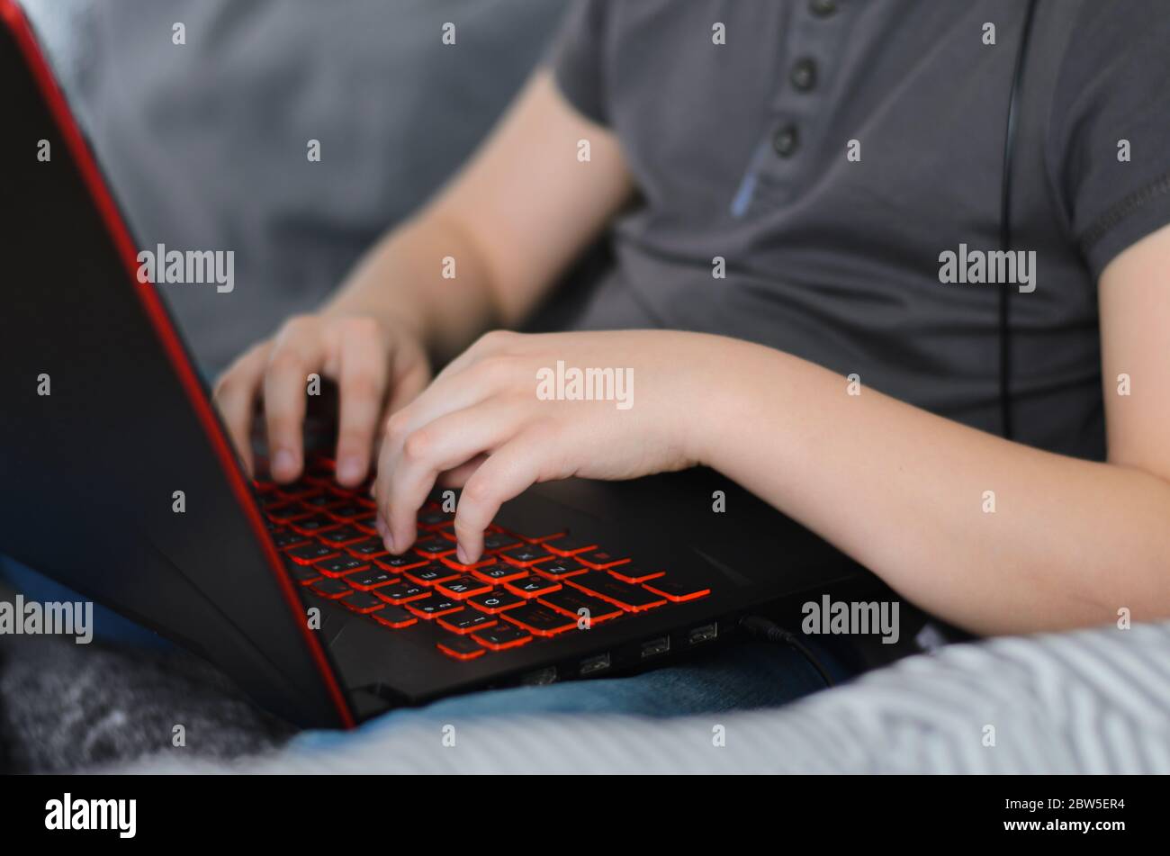 Child playing or studying on laptop computer at home. Technology ...