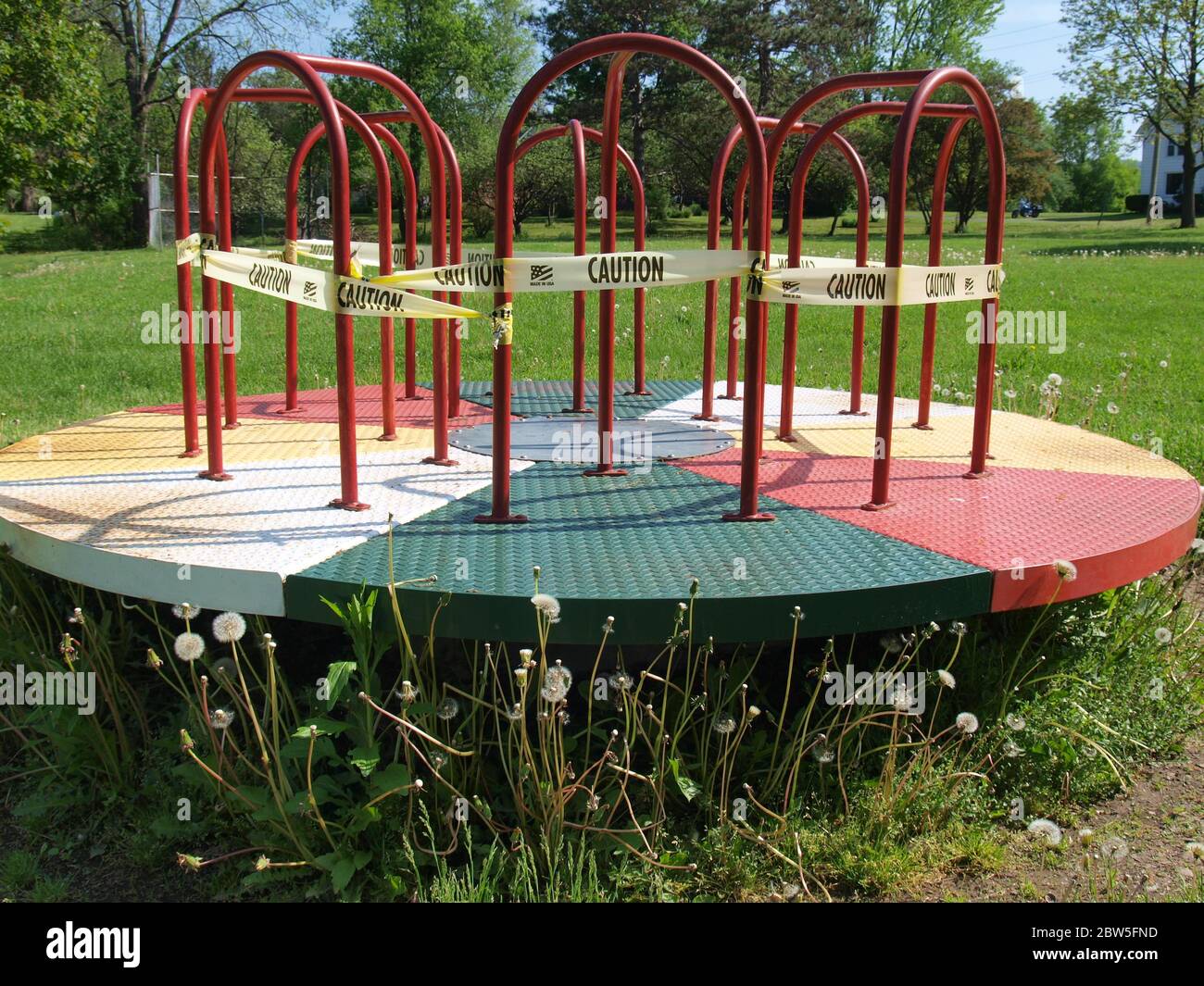 An abandoned-looking park merry-go-round for children is blocked off ...