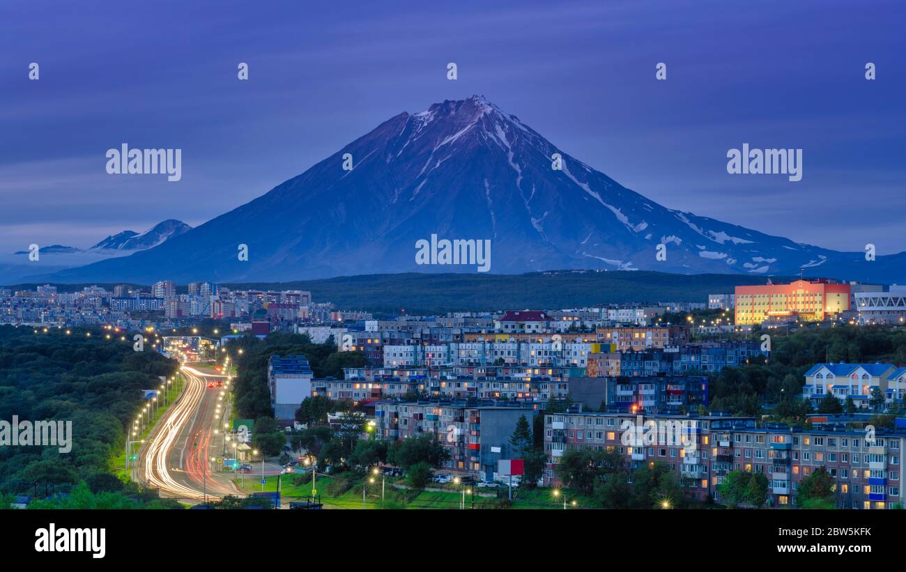Panorama of night city of Petropavlovsk-Kamchatsky on background cone ...