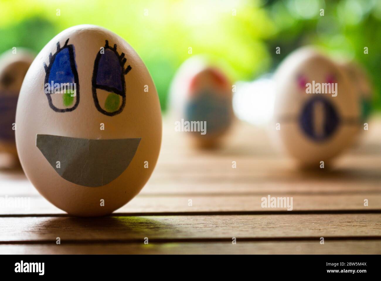 Funny eggs with human faces. Eggs wearing face masks or chinstraps ...