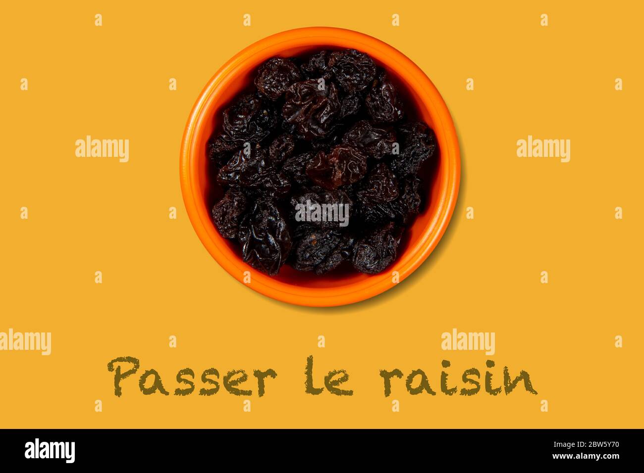 Orange bowl with culinary ingredients Pass grape (text in french) on ...