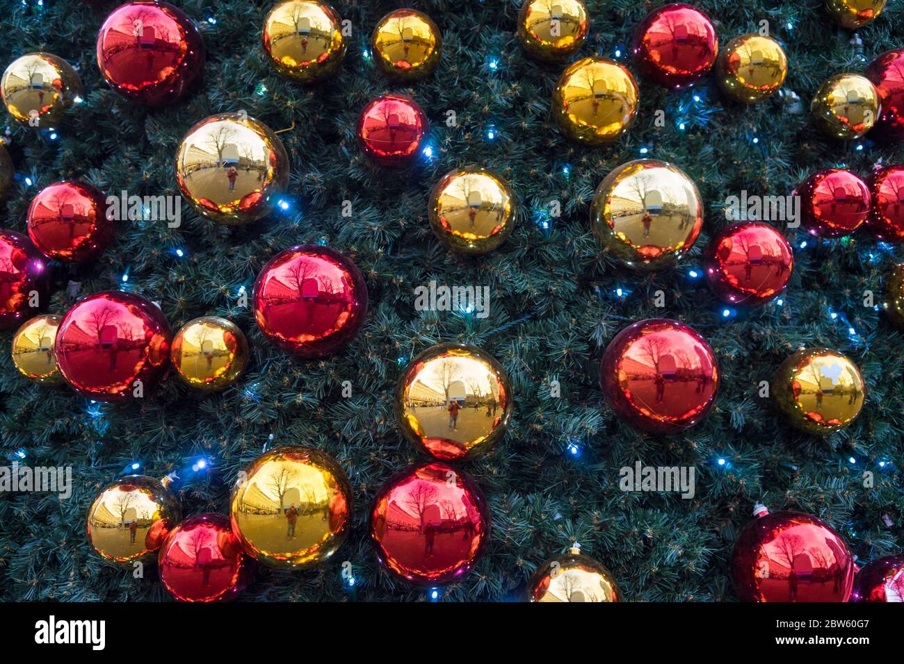Red and gold ball decorations on a Christmas tree with lights on Stock ...