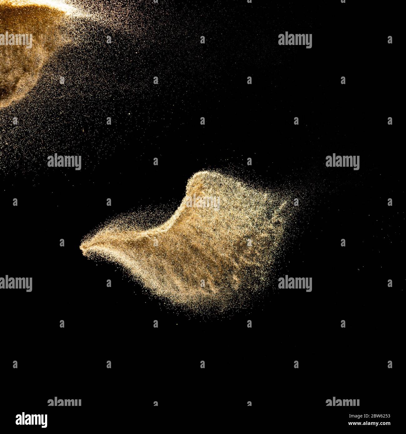 Dry river sand explosion.Brown color sand splash against black ...