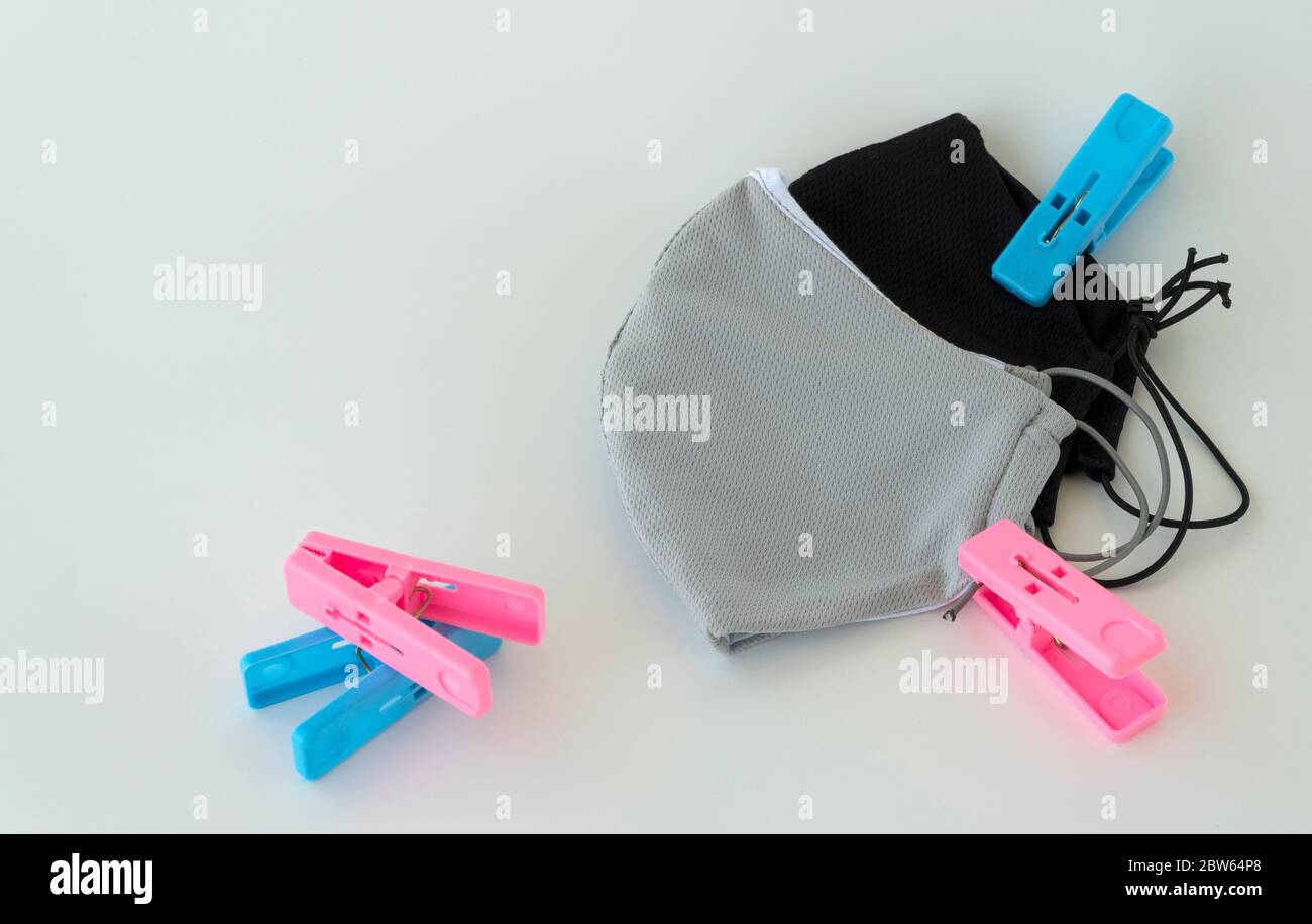 reusable medical masks and clothespins on a white background Stock ...