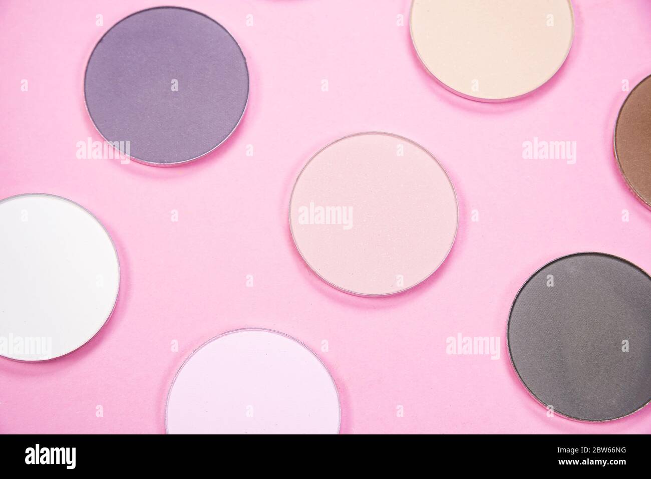 Pattern of eye shadows of different colors on a pink background Stock ...